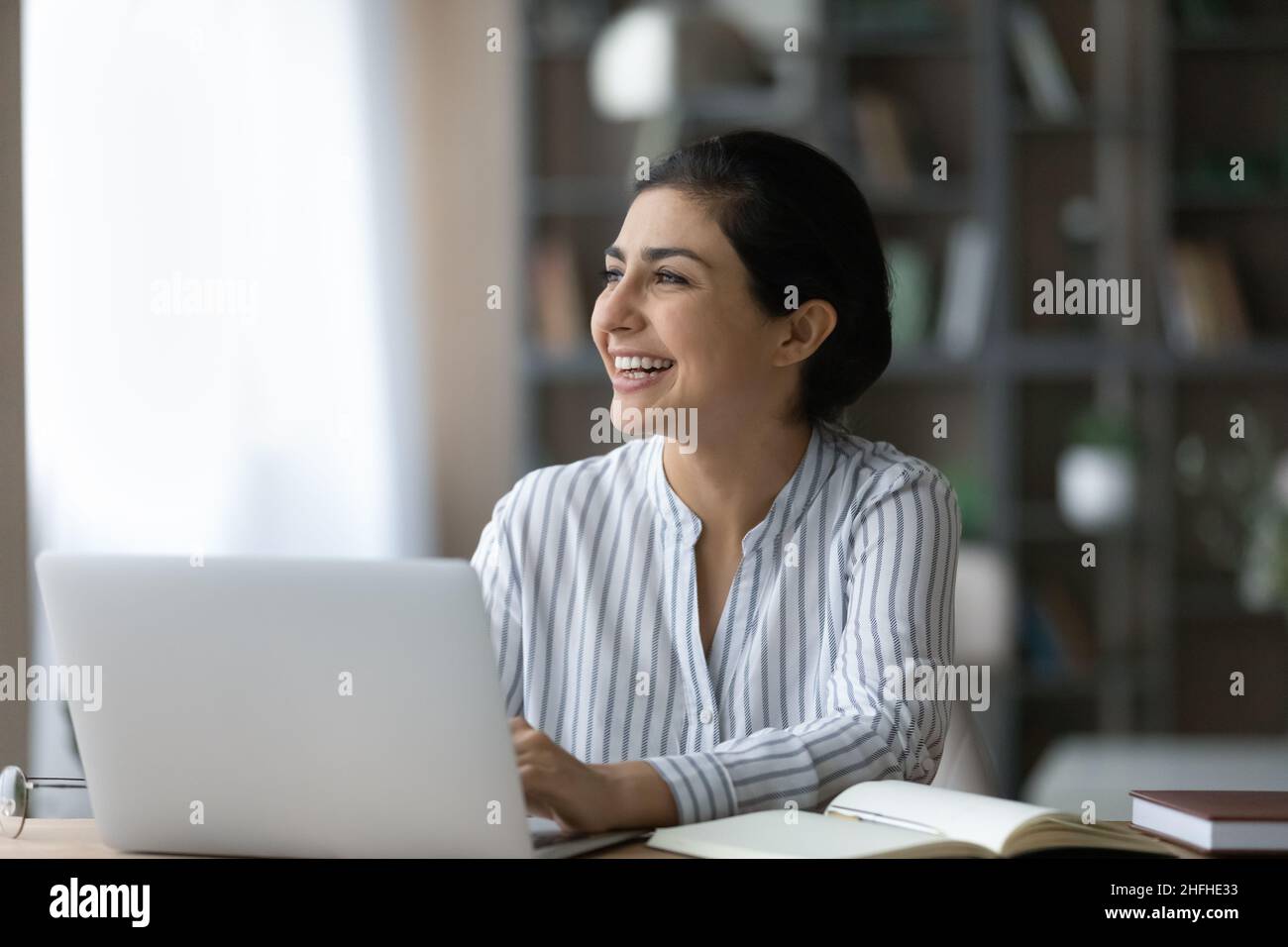 Happy millennial Indian woman working in modern office Stock Photo - Alamy