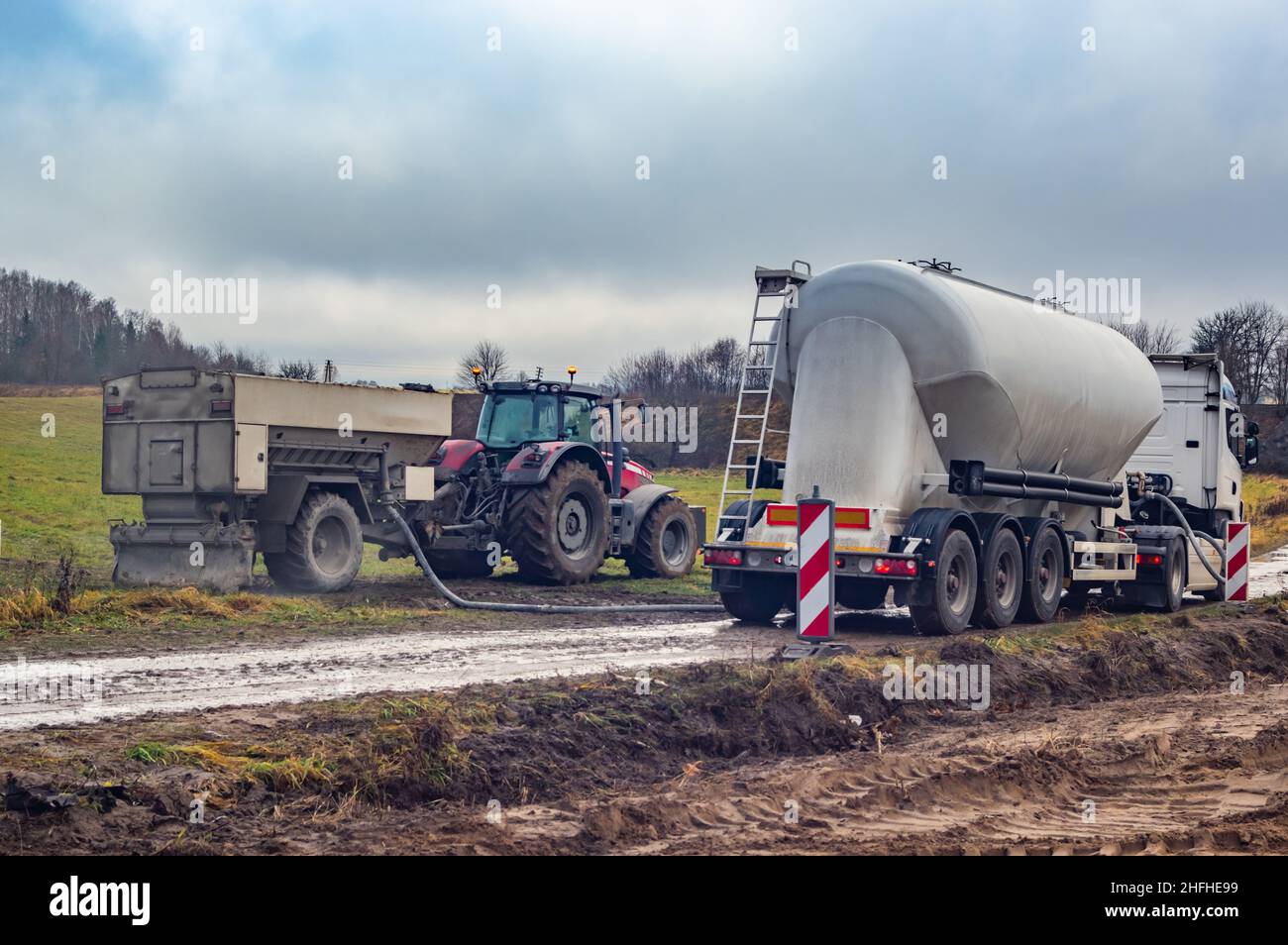 binding agent spreader in trailer and cement tank truck on site Stock ...