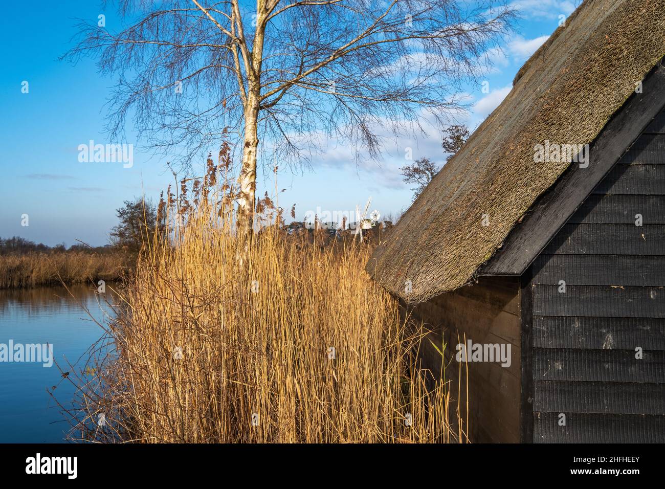 Ludham, Norfolk, UK – January 2022. Wooden boat shed with thatched roof ...