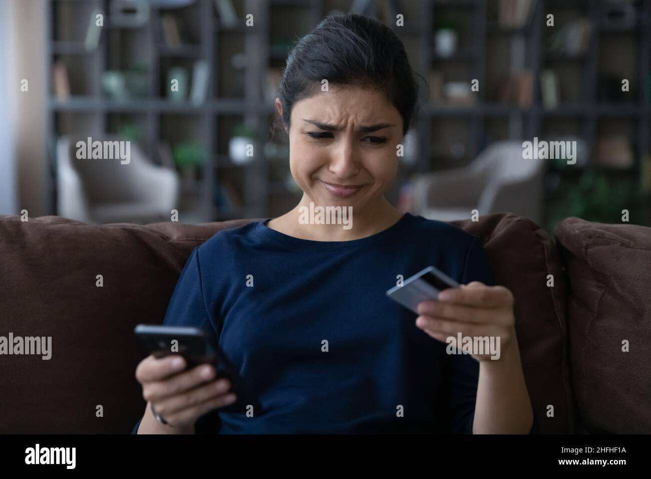 Stressed frustrated young Indian woman having problems with internet ...