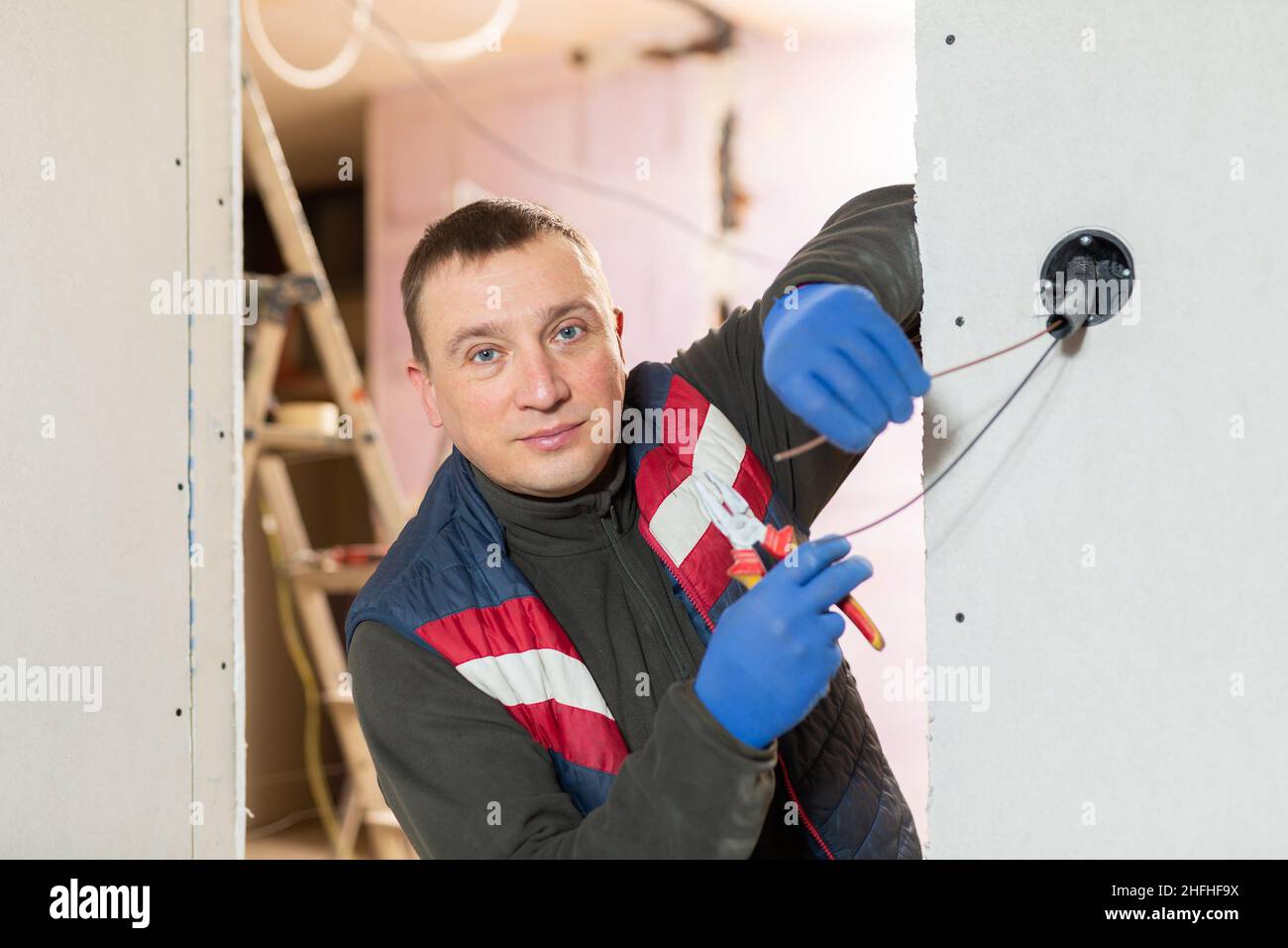 Repair man working on electric wires Stock Photo - Alamy