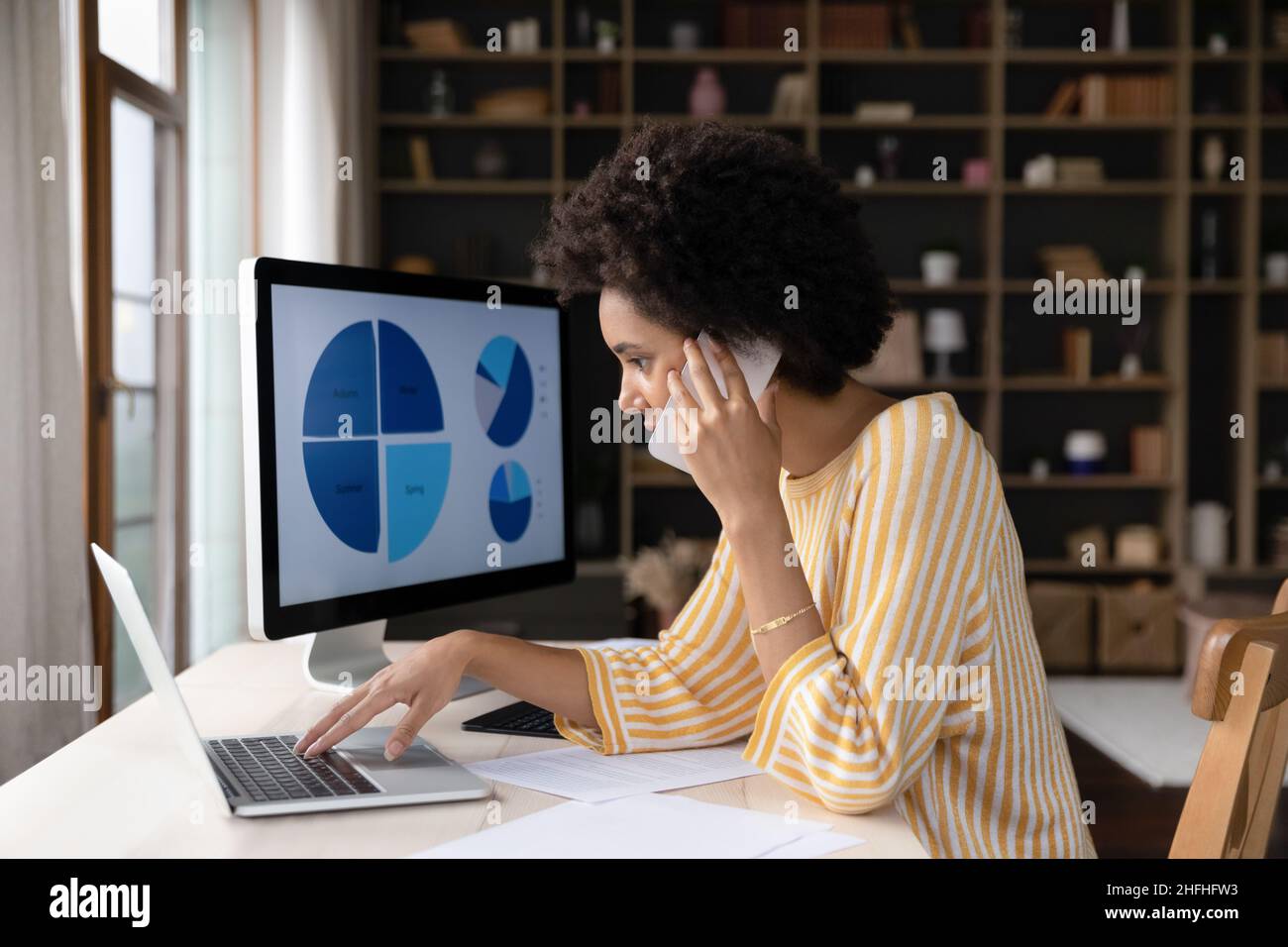 Concentrated African American businesswoman multitasking in modern ...