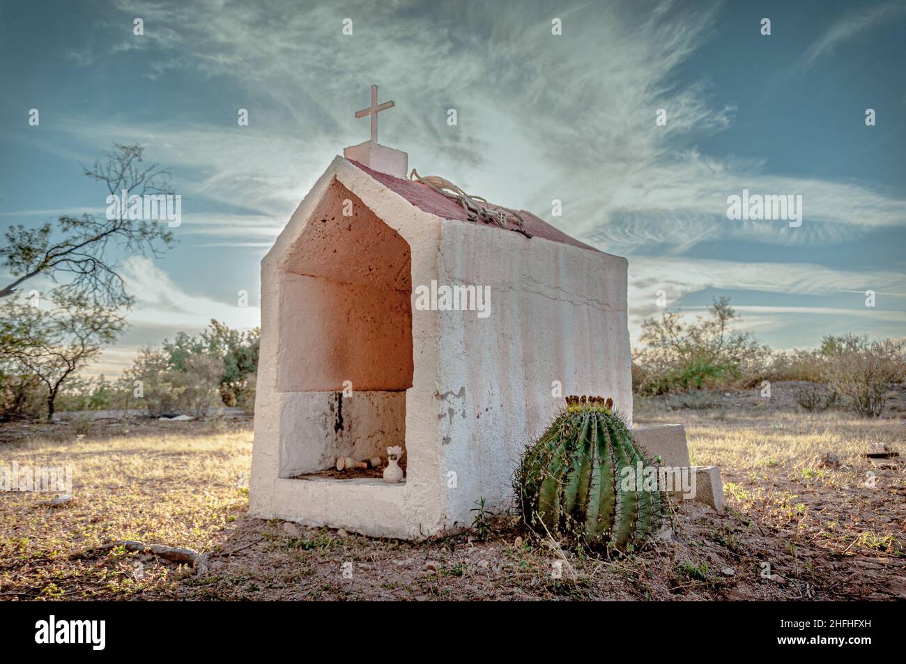 A yard shrine in the desert of Mexico, a barrel cactus and a dramatic ...