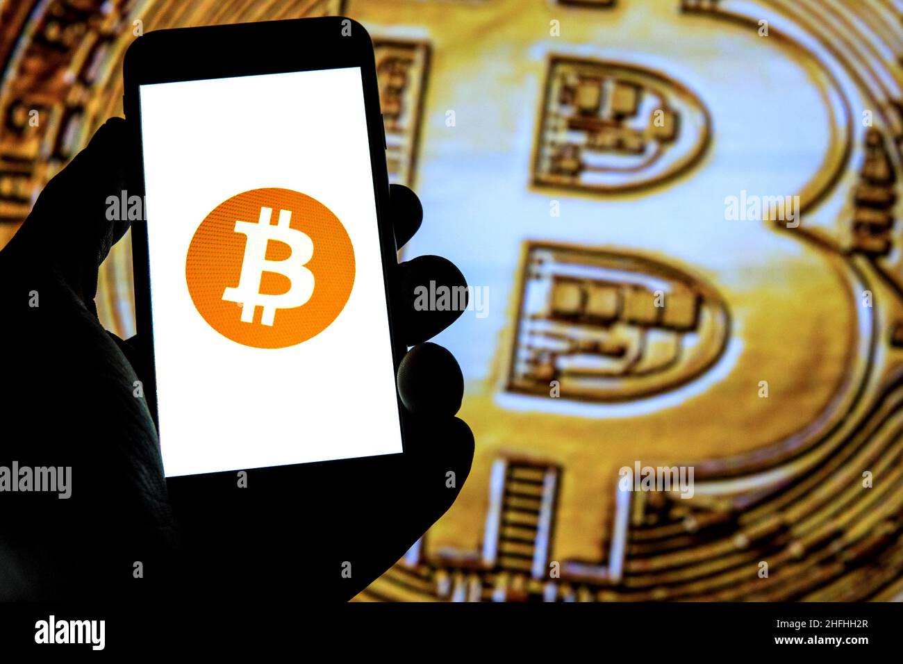 In this photo illustration a Bitcoin logo seen displayed on a ...