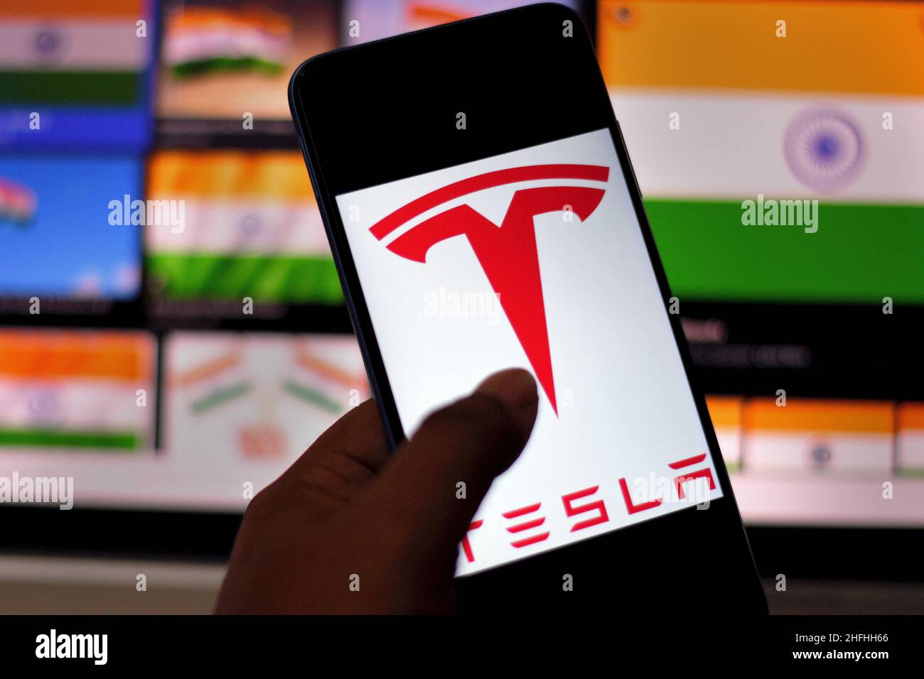In this photo illustration, a Tesla logo seen displayed on a smartphone ...