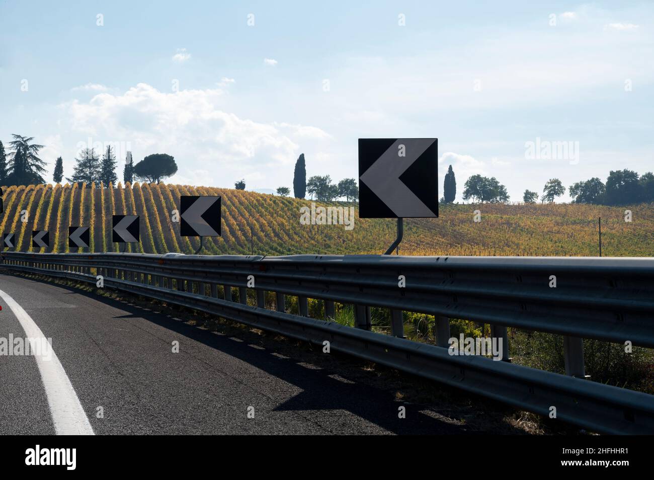 Driving car on Italian highway with view on Chianti vineyards on hills ...