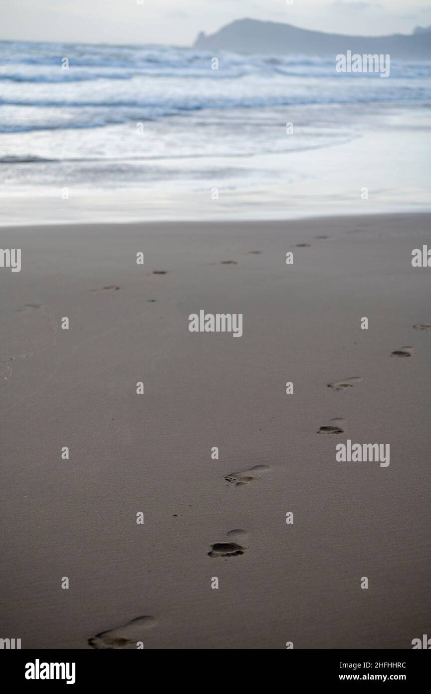 Footsteps on sandy beach and stormy high sea waves at winter Stock ...
