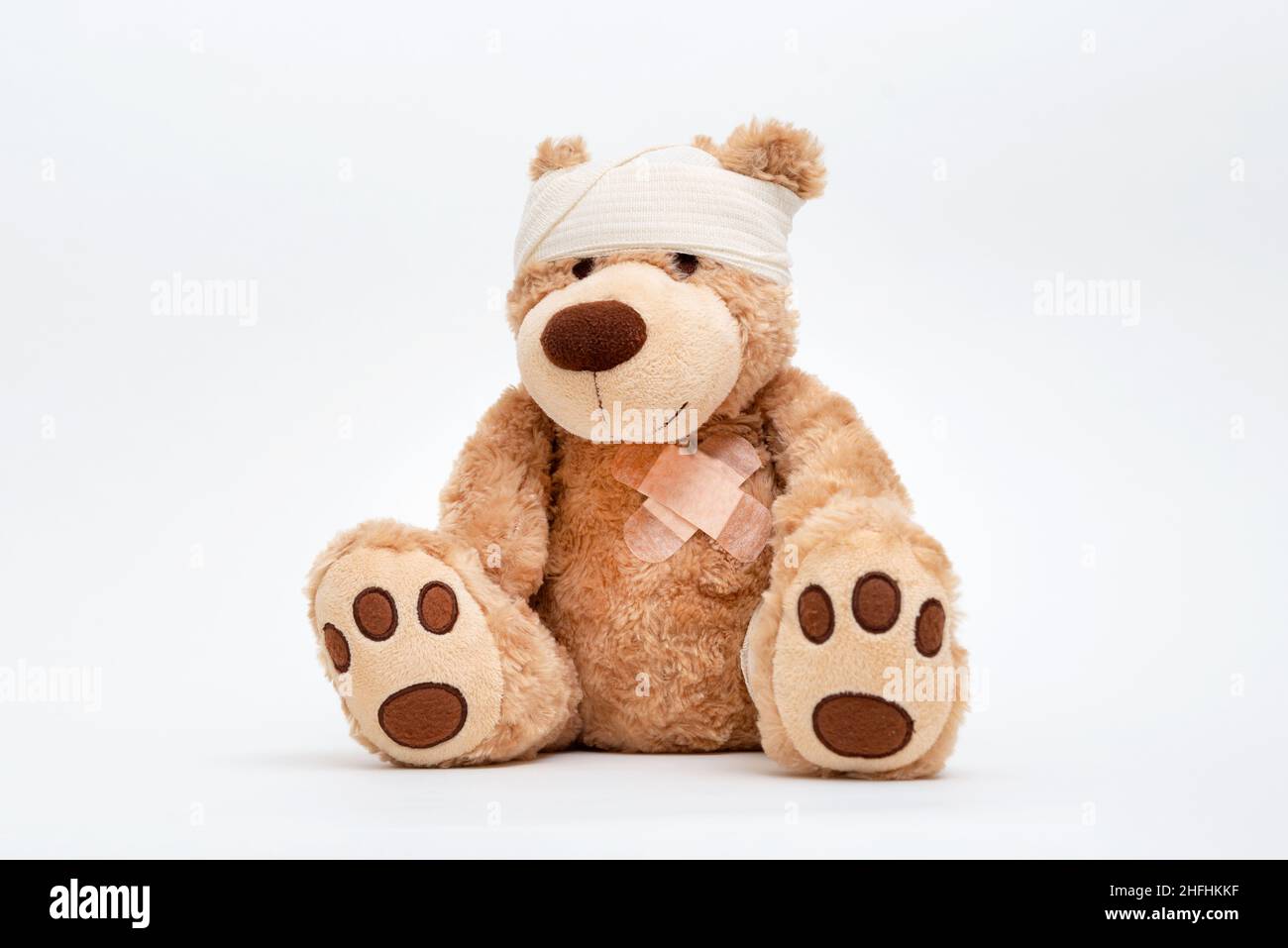Teddy bear with bandage, child medical care concept. Bear on white ...