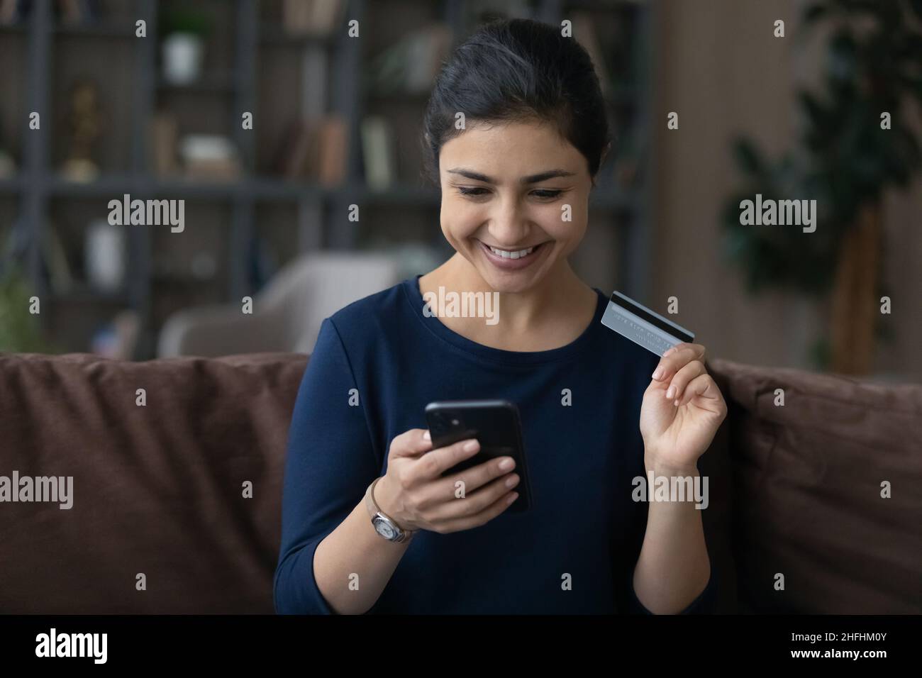 Happy Indian woman purchasing goods in internet store Stock Photo - Alamy