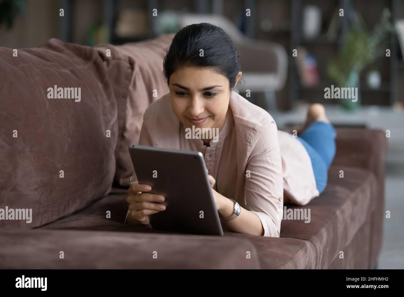 Cheerful young Indian woman using digital computer tablet Stock Photo ...
