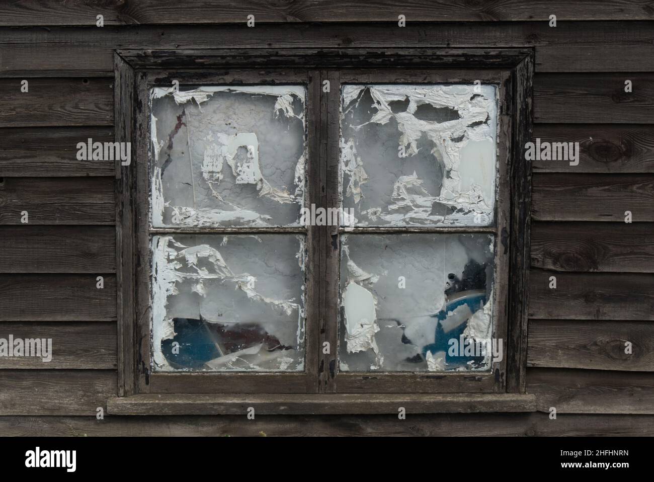 A boarded up window in an old wooden shack Stock Photo - Alamy