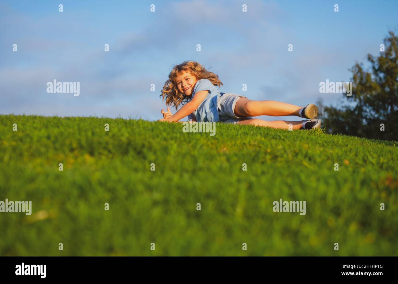 Boy falling down on grass. Kid falling off at the park Stock Photo - Alamy