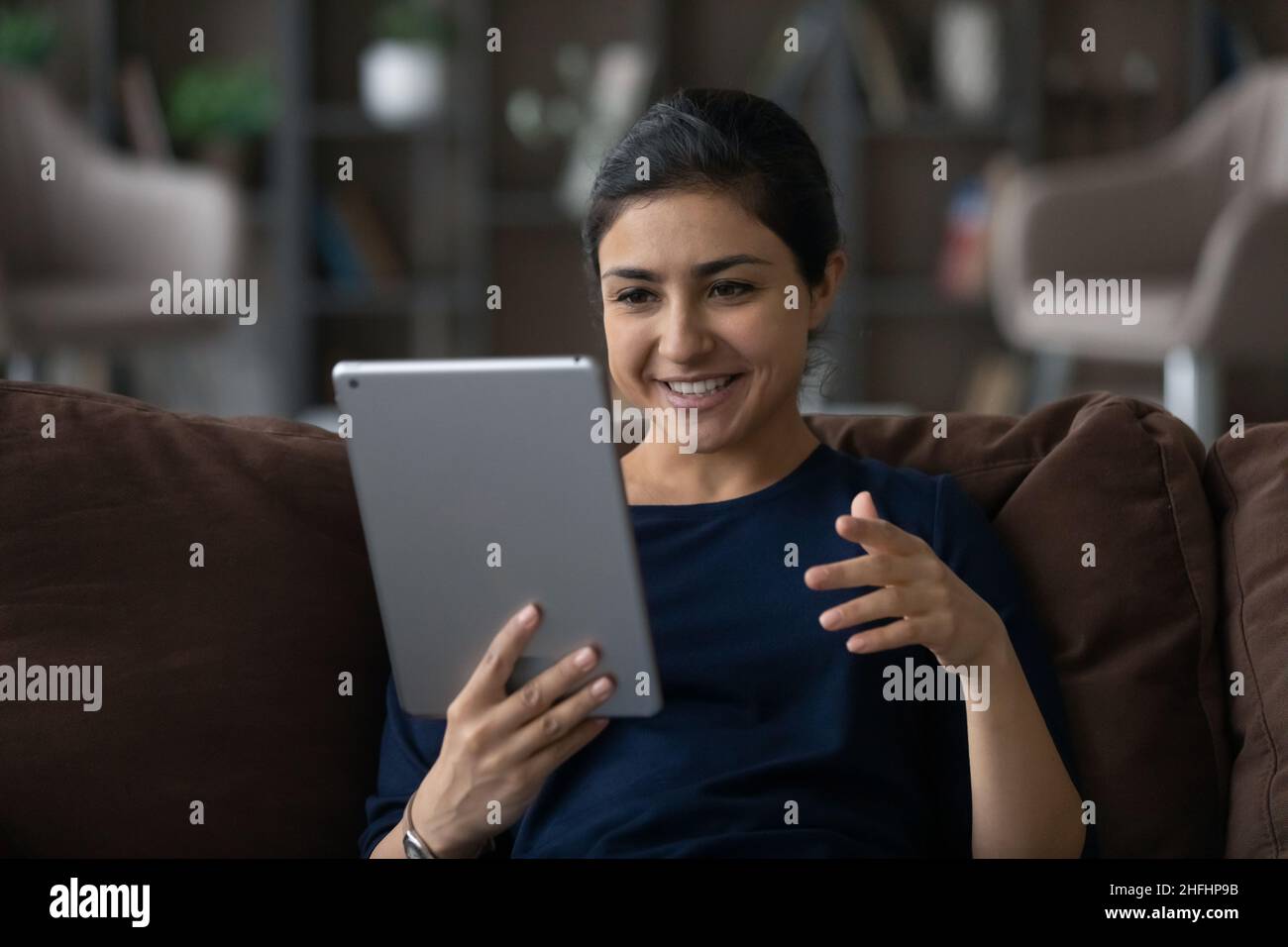 Happy attractive young Indian woman holding video call conversation ...
