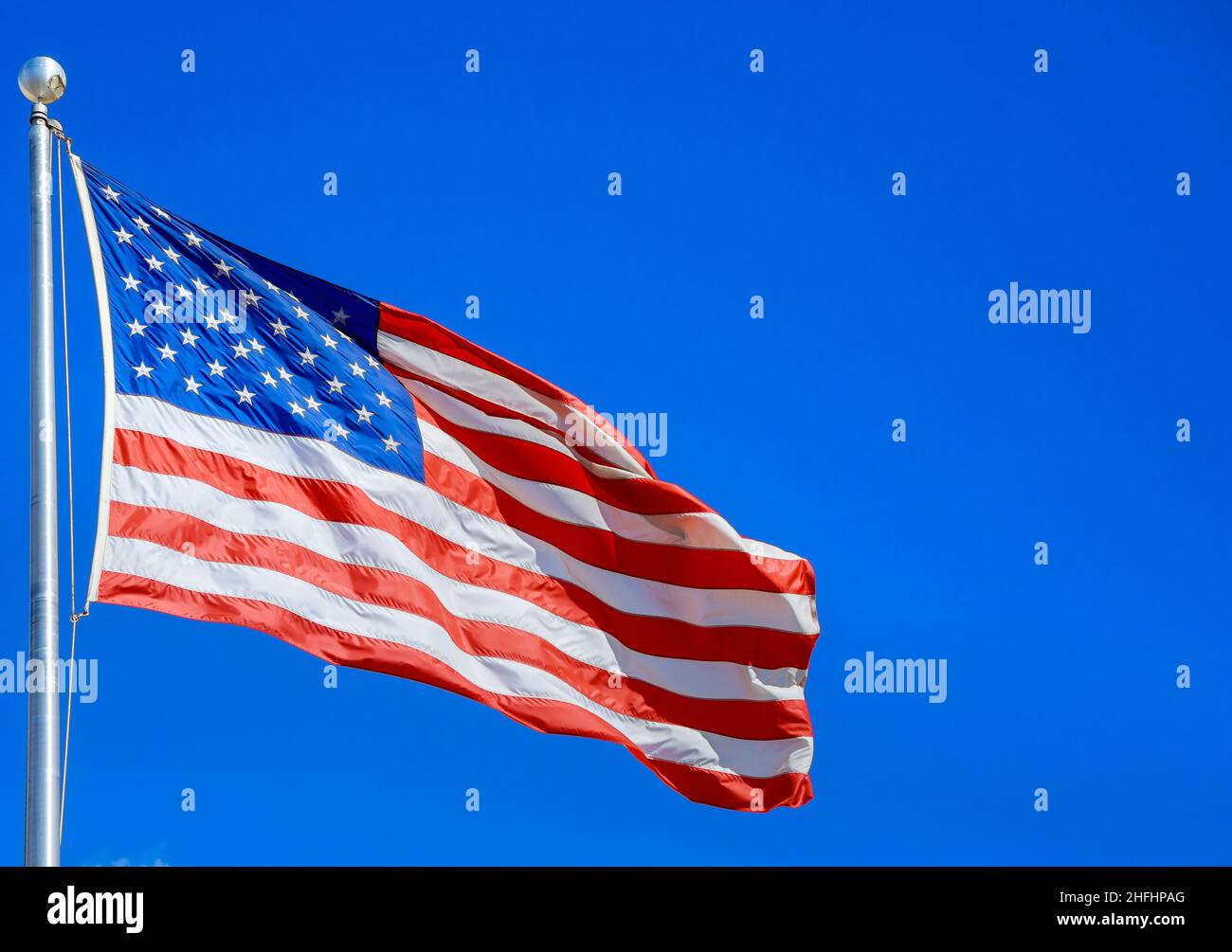 USA flag on flagpole with American flag - symbol of freedom and law in ...