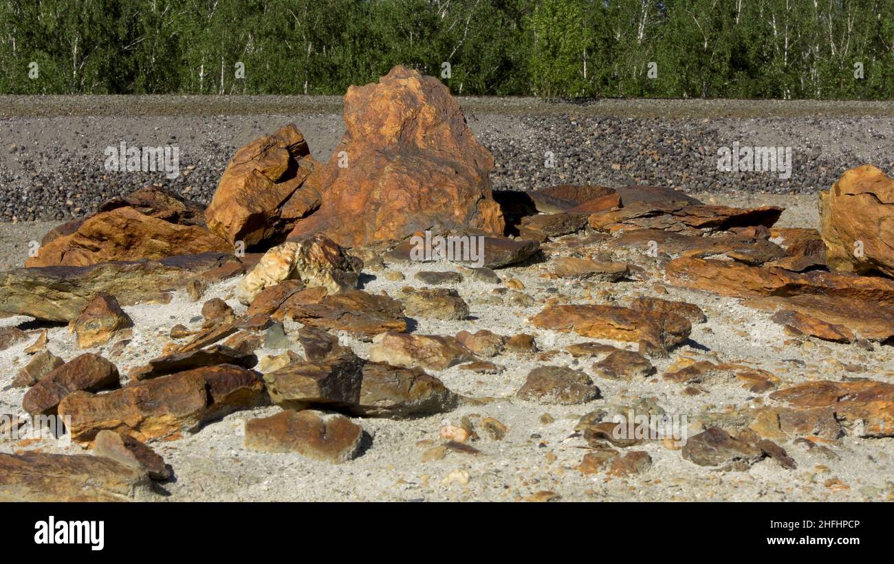Beautiful brown stones of diferent size under the summer sun on quarry ...