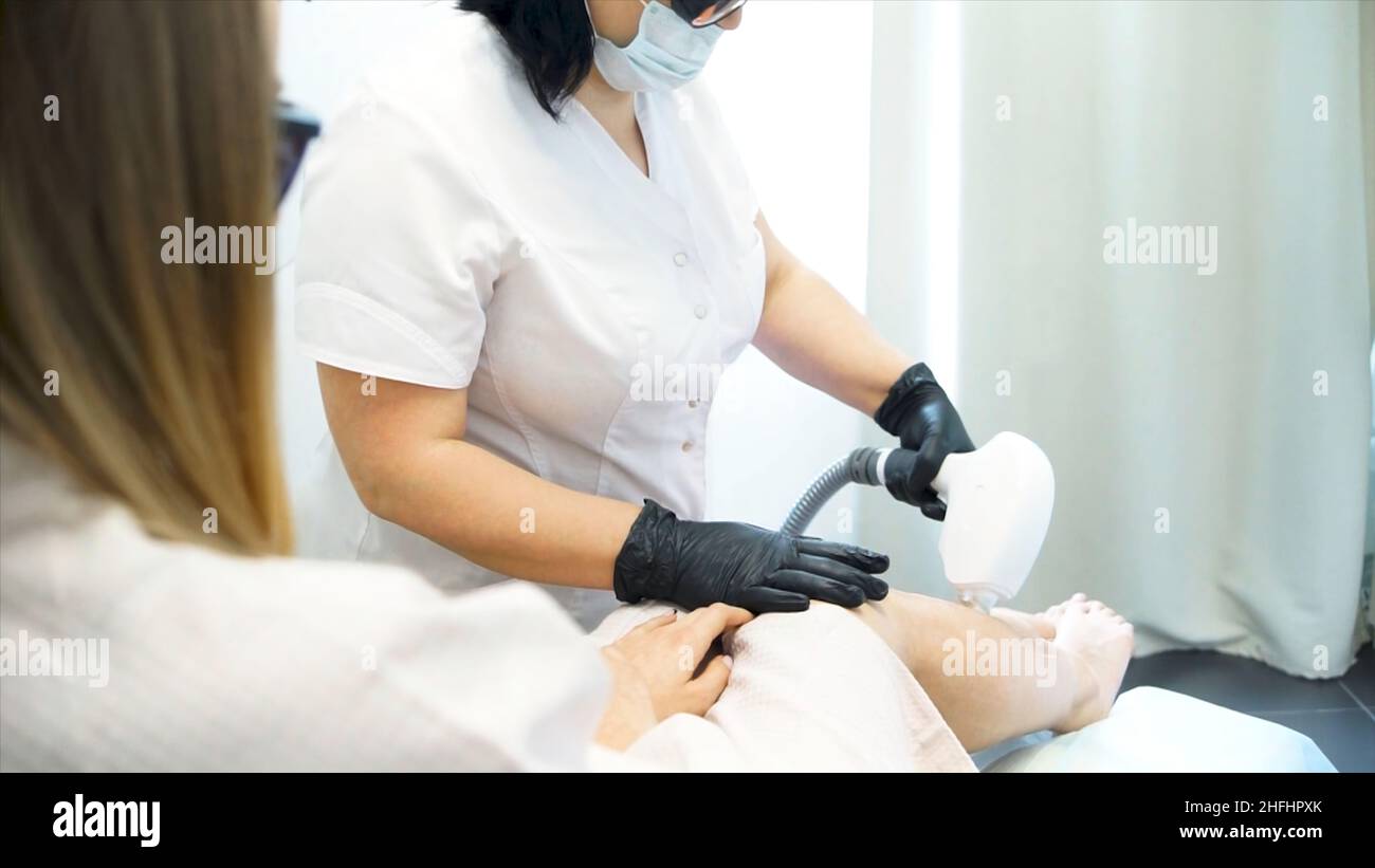 Close-up Of A Beautician Waxing Womans Leg In Beauty Spa. Process ...