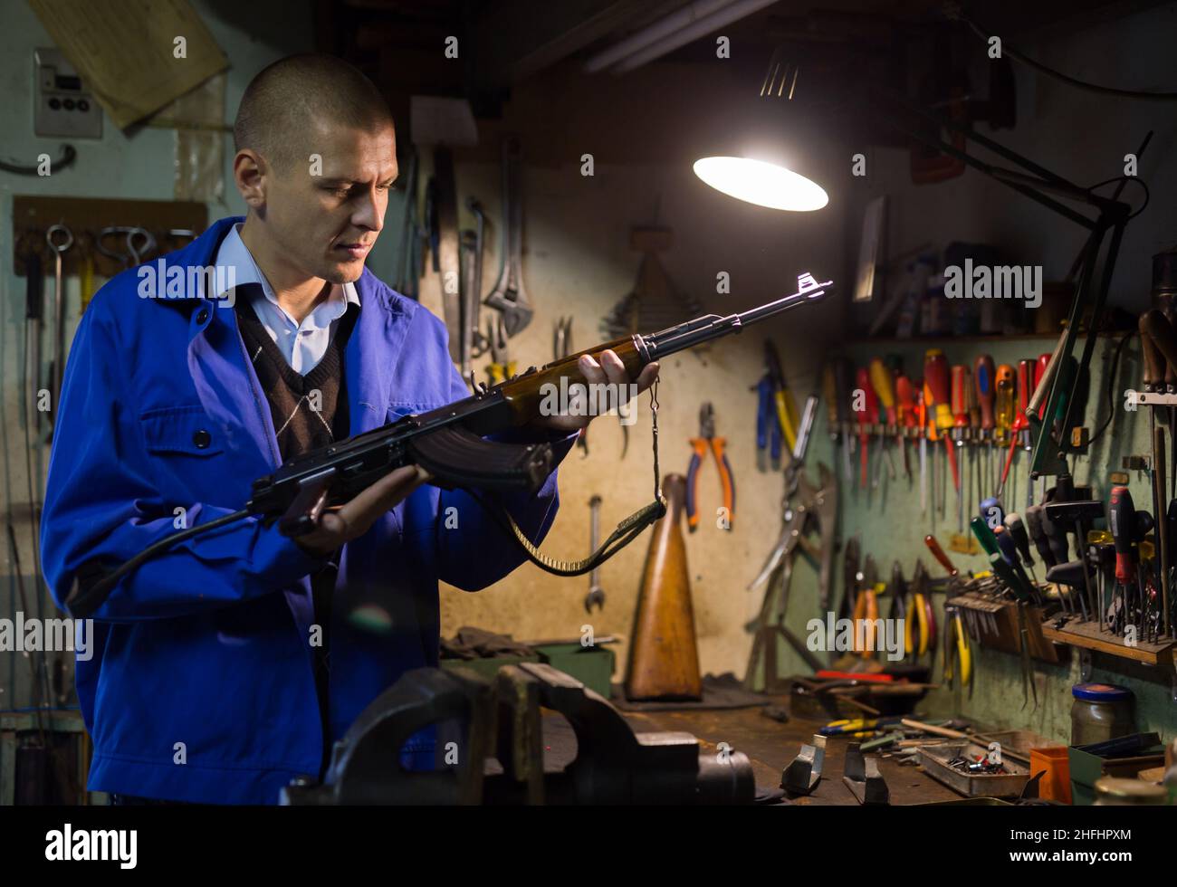Gunsmith checks Kalashnikov assault rifle in weapons workshop Stock ...