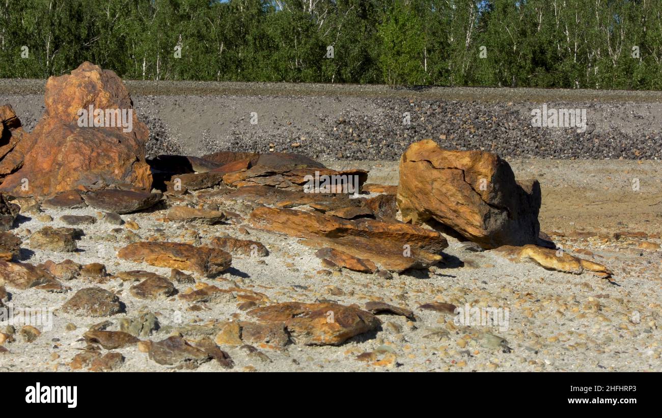Beautiful brown stones of diferent size under the summer sun on quarry ...