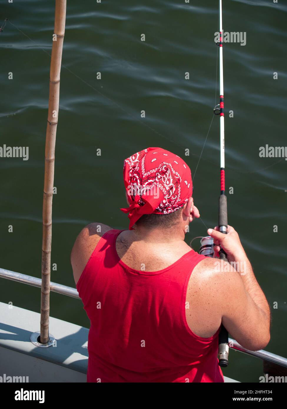 Reeling in Charter fishing boat Stock Photo - Alamy