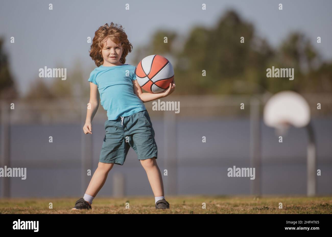Child boy preparing for basketball shooting. Kid posing with a ...