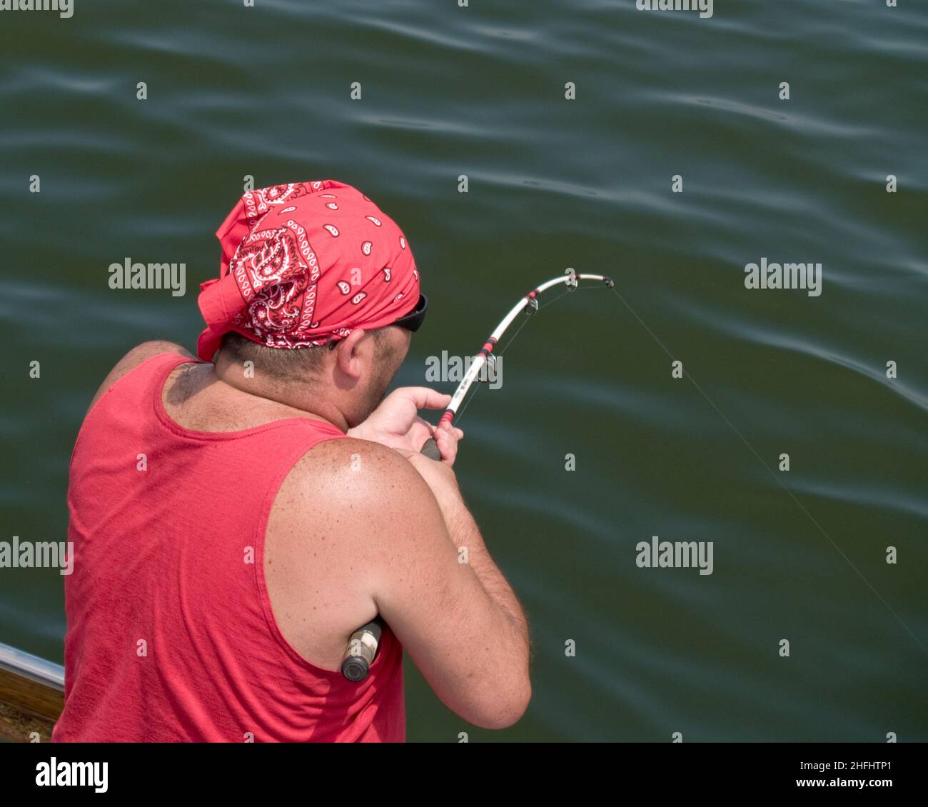 Reeling in Charter fishing boat Stock Photo - Alamy