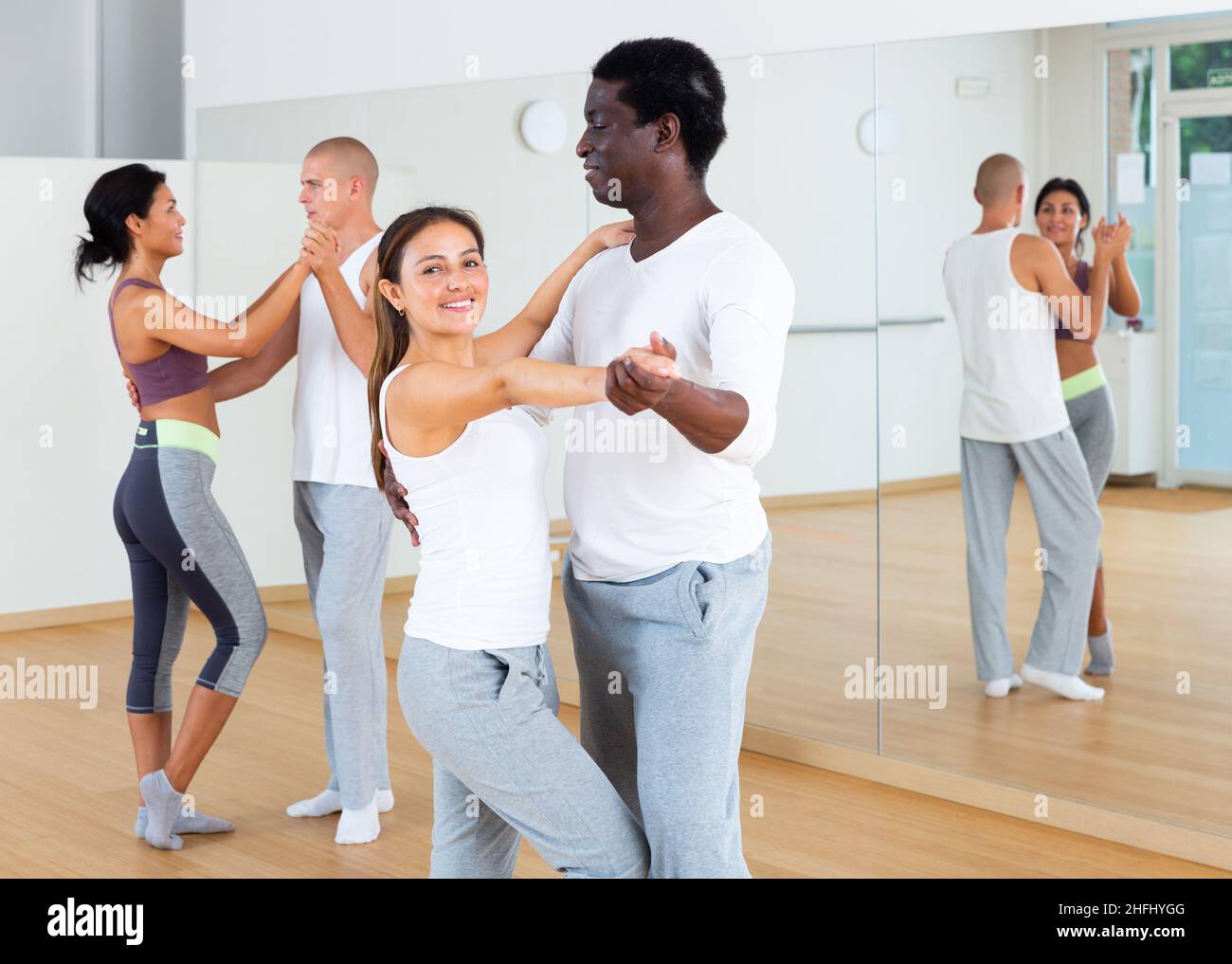 Young couples practicing active dance in pair Stock Photo - Alamy