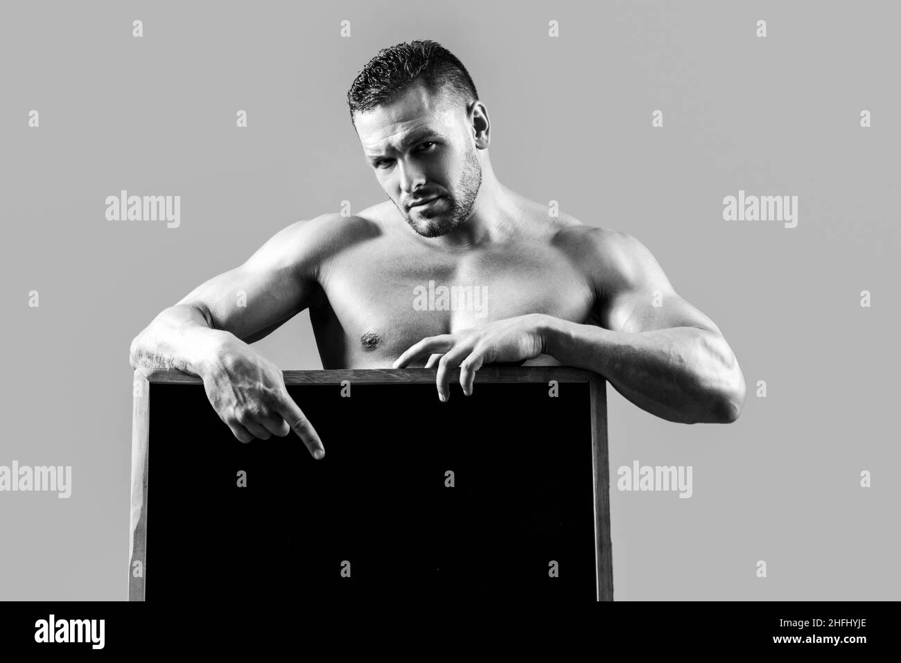 Fitness man with advertising sign board. Handsome muscular bodybuilder ...