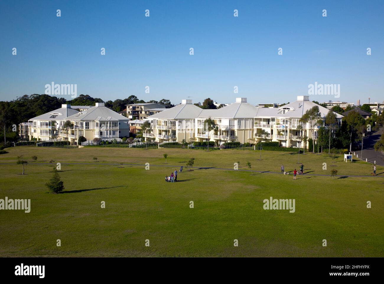 Colour photograph of parkland and apartments, Breakfast Point ...