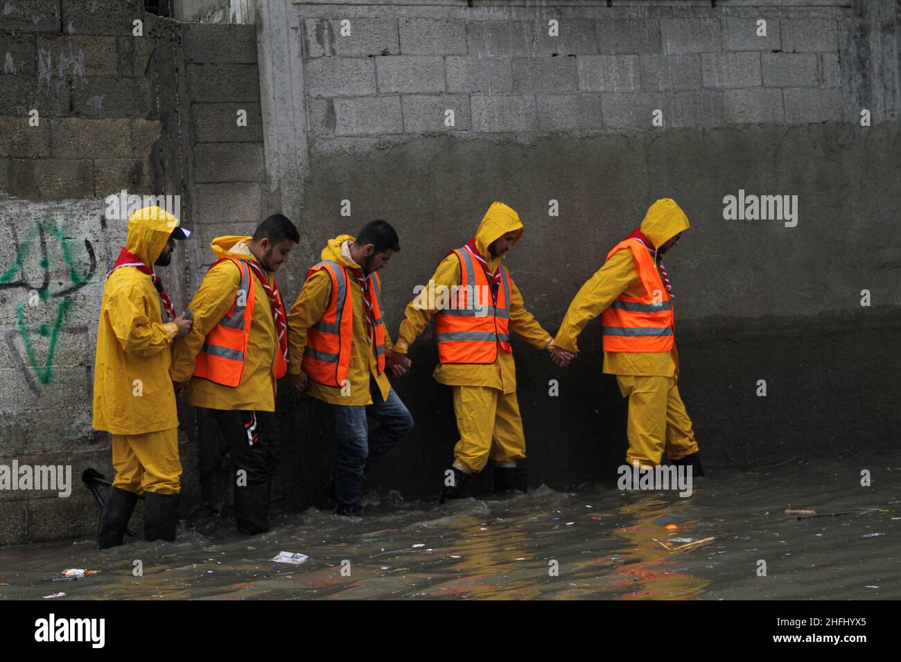 Residents wade through flooded road hi-res stock photography and images ...