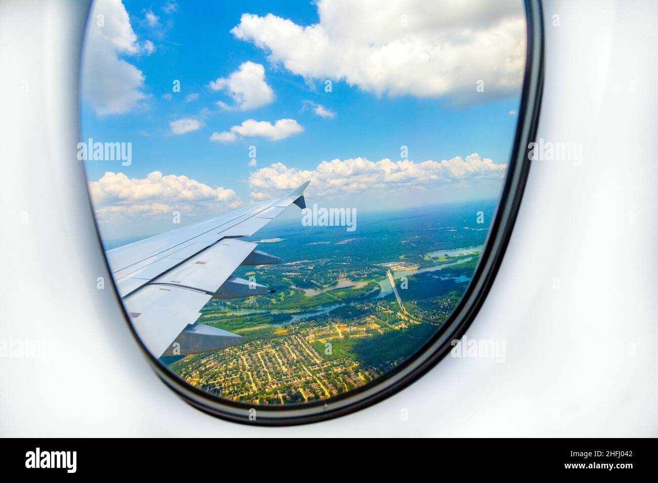 lookout of aircraft window to landscape while landing Stock Photo - Alamy