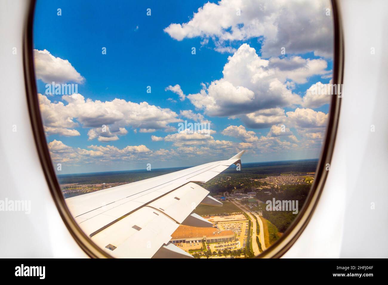 lookout of aircraft window to landscape while landing Stock Photo - Alamy