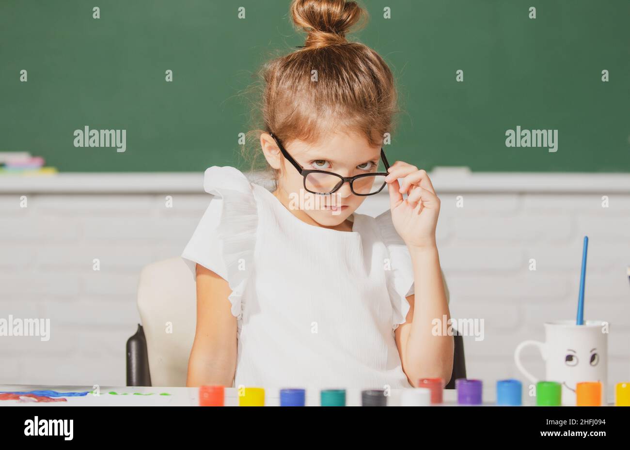 Child girl drawing with coloring pens paintind. Portrait of adorable ...