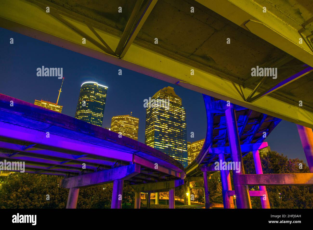 View on downtown Houston by night with bridges in colorful light with ...