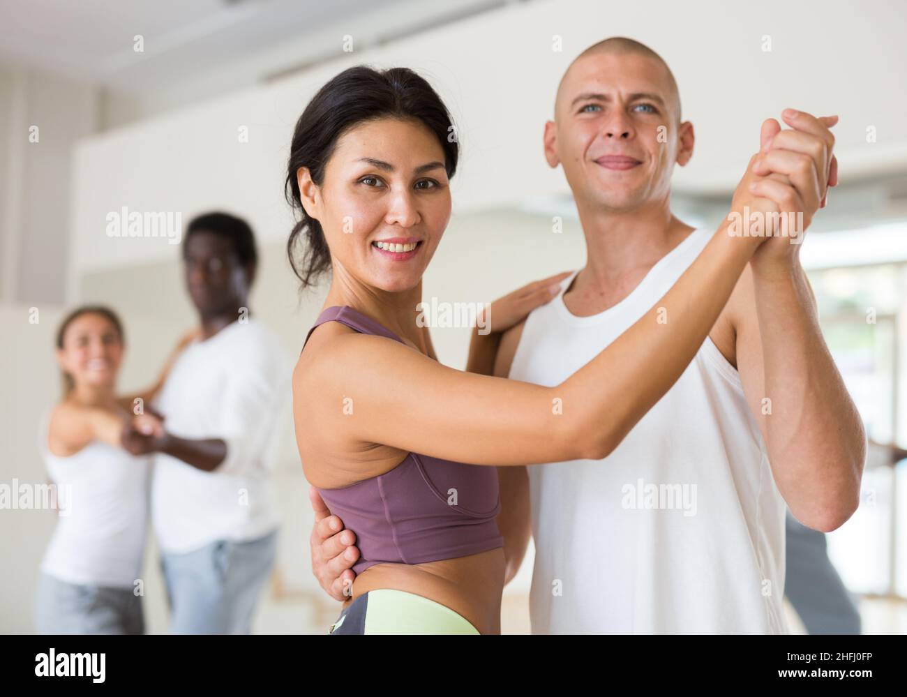 Young couples practicing active dance in pair Stock Photo - Alamy