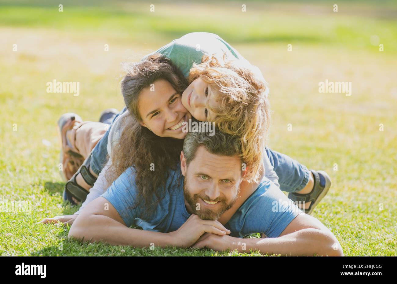 Happy family hugging and embracing on summer walk. Father mother and ...