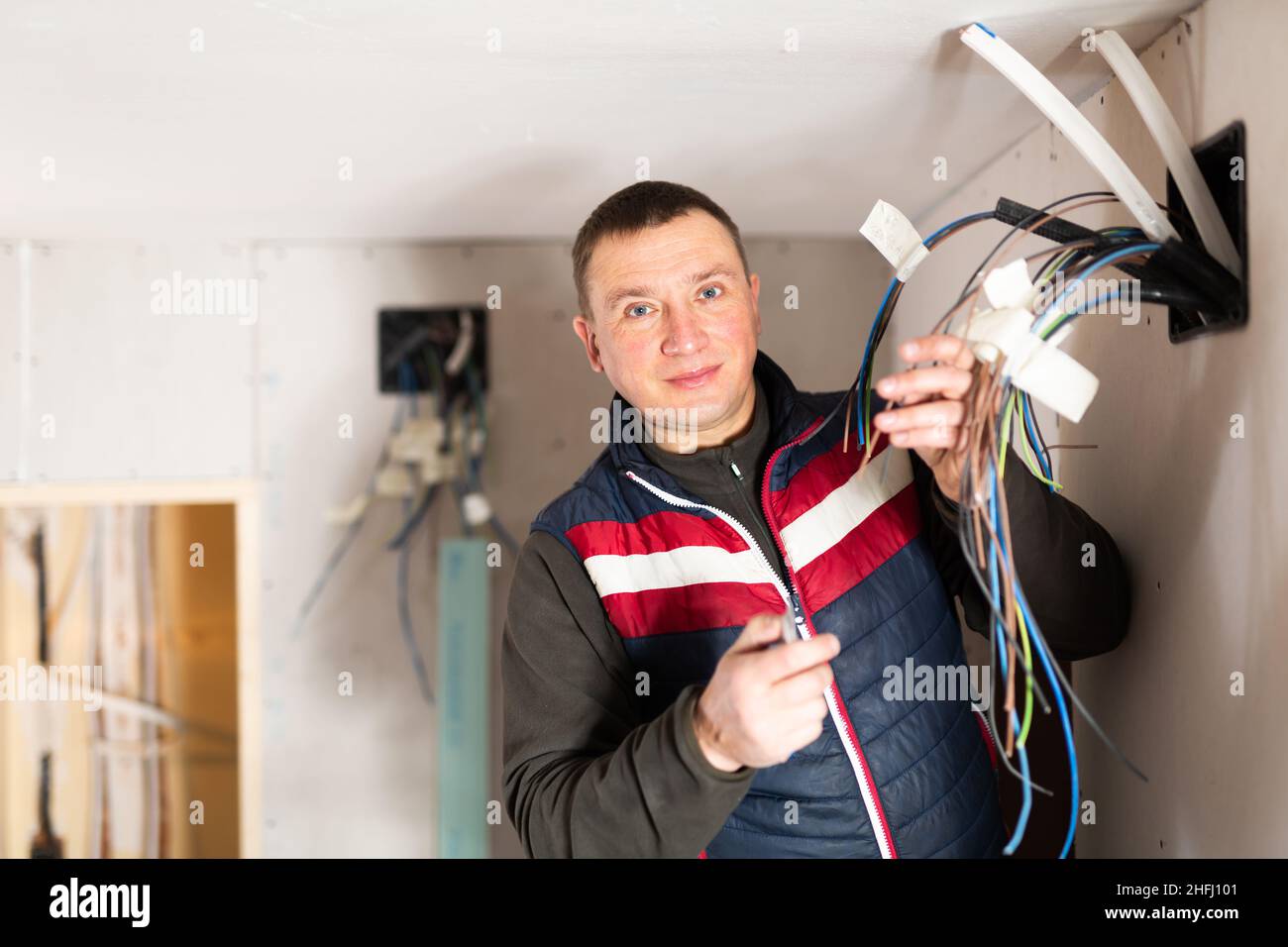 Repair man working on electric wires Stock Photo - Alamy