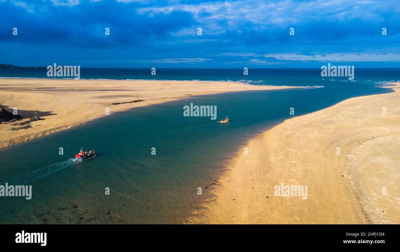 Fishing boats heading out to sea Stock Photo - Alamy