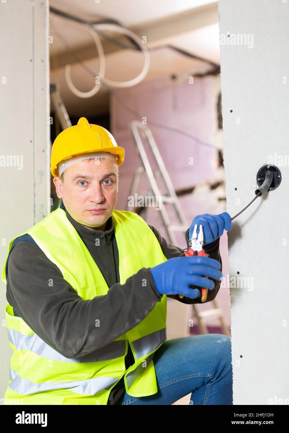 Repair man working on electric wires Stock Photo - Alamy