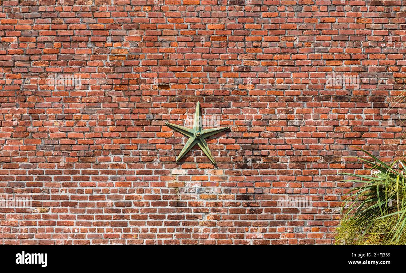 Background of brick wall texture with architectonic star construction ...