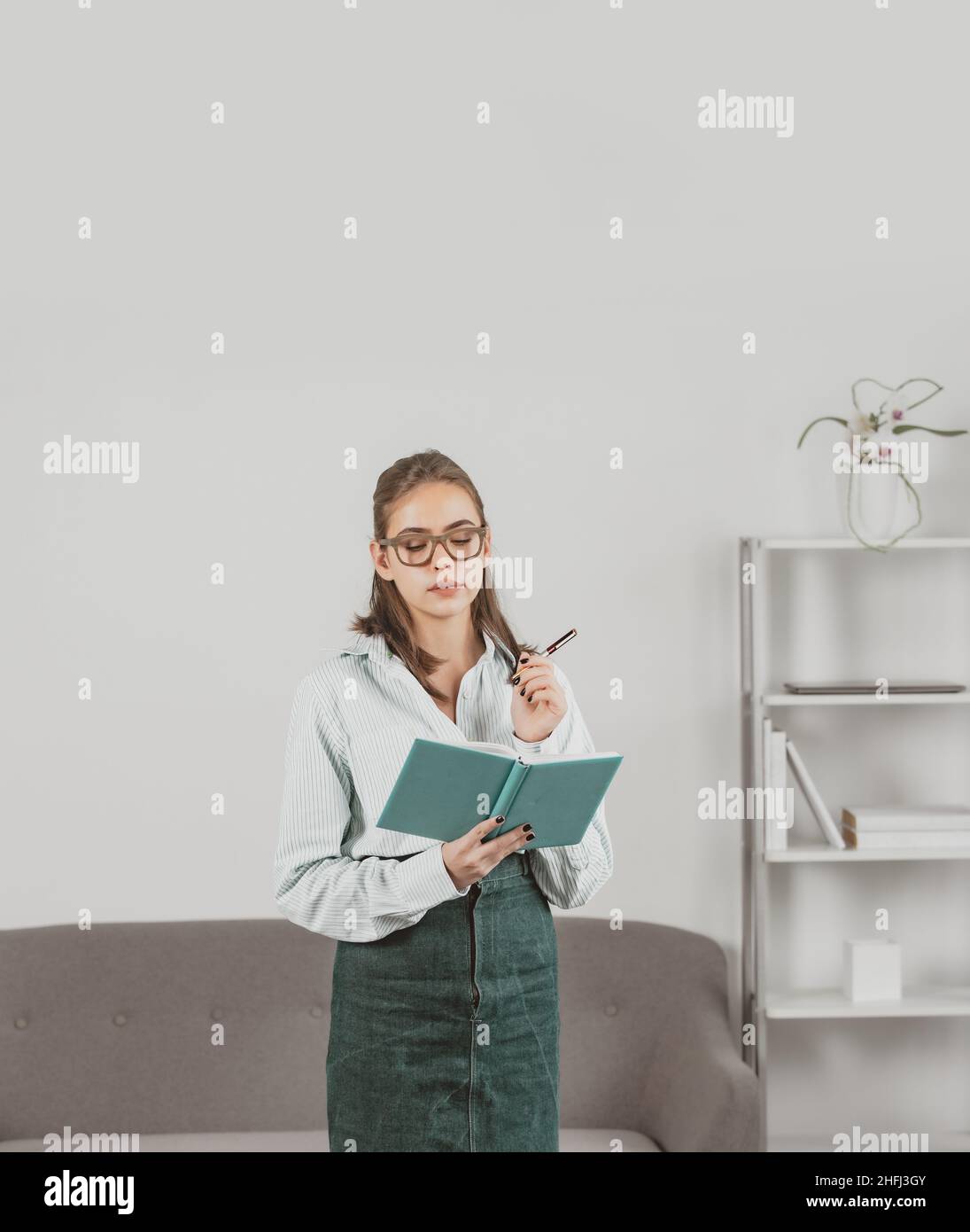 Thinking student Young attractive secretary woman holding note book or ...