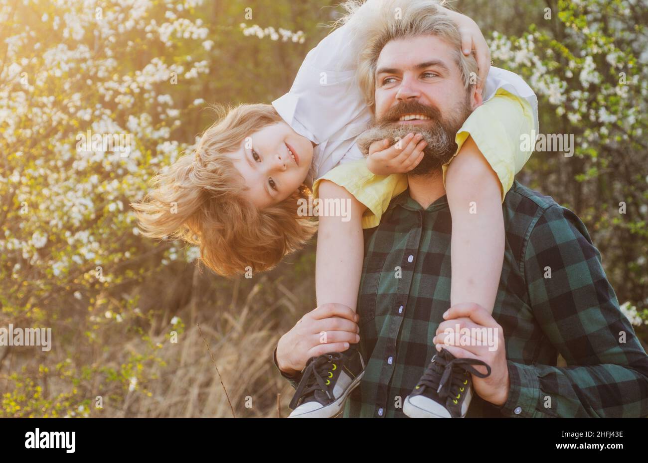 Happy child with father in spring park. Happy dad and son. Fathers day ...