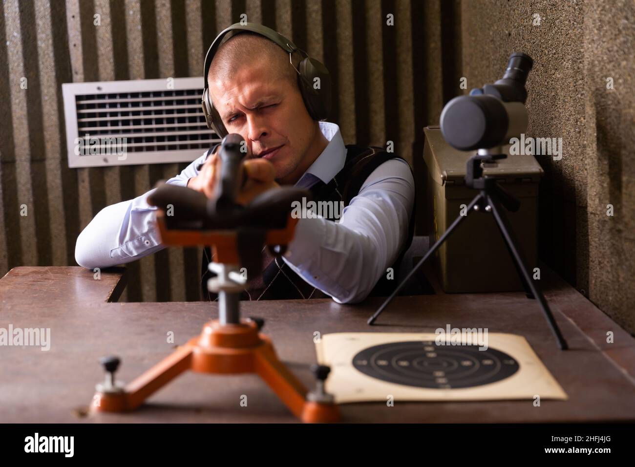Man zeroing hunting rifle from bench rest in shooting range Stock Photo ...
