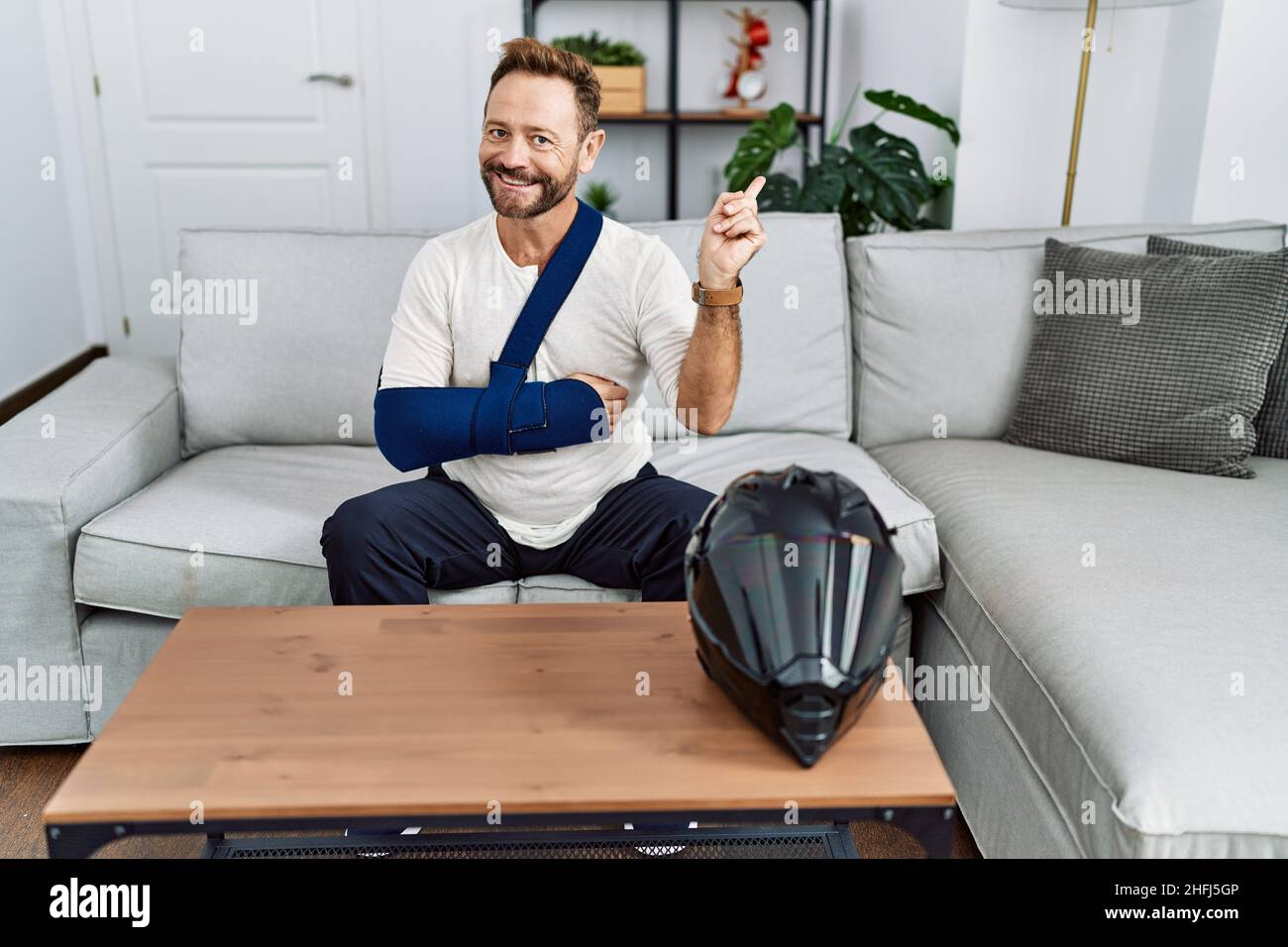 Middle age man with beard wearing arm on sling because motorbike ...