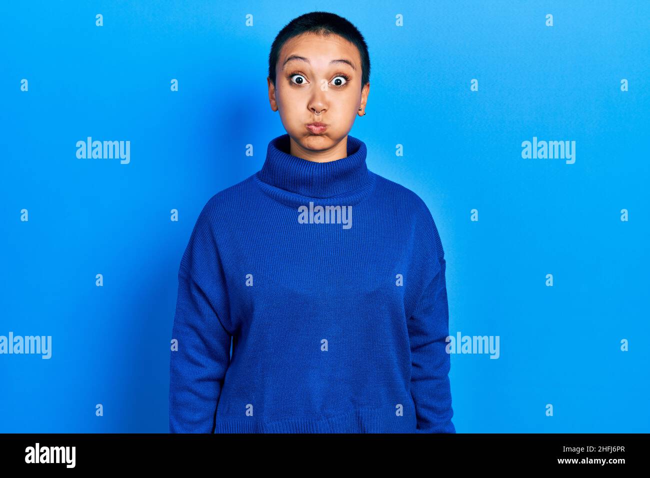 Beautiful hispanic woman with short hair wearing turtleneck sweater ...