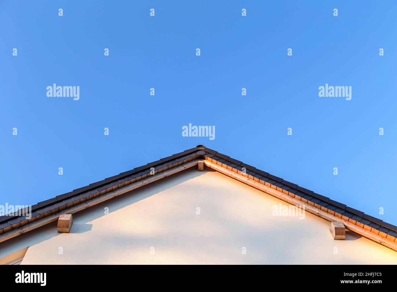 house facade with gable and roof pattern under blue sky Stock Photo - Alamy