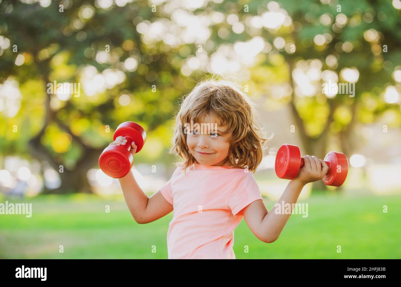 Kids sport exercising in park. Children healthy lifestyle. Sport child with strong muscles Stock ...