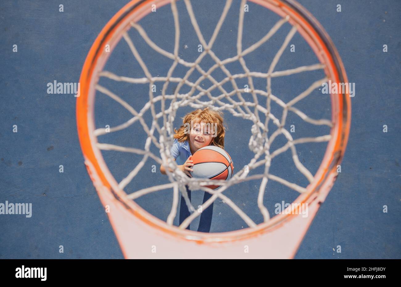 Angle view from on top of kid playing basketball on playground Stock ...