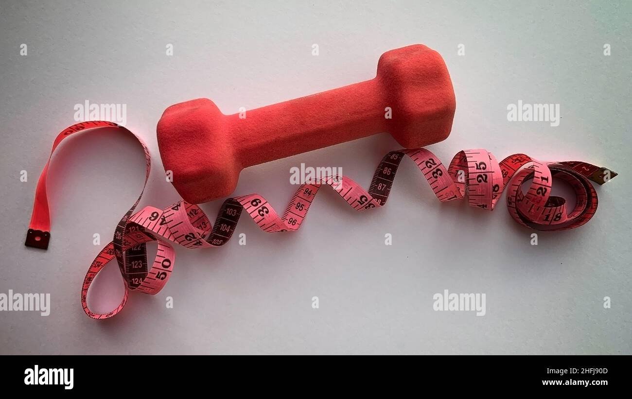 Diet and weight loss Concept. Top view of dumbbell and weight scale ...