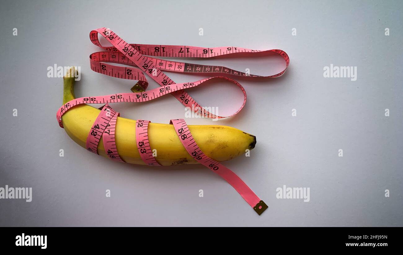 Diet and weight loss Concept. Top view of banana, weight scale measure ...