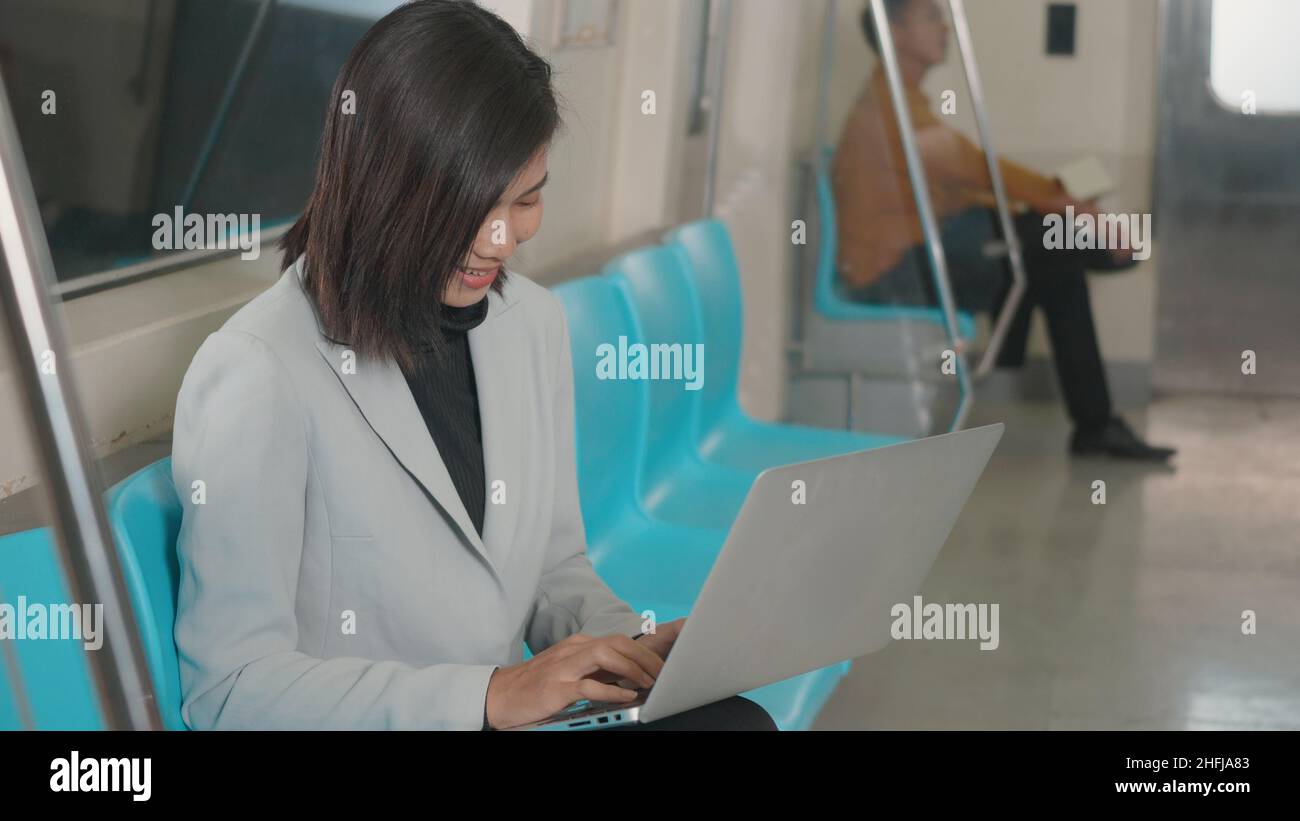 Young Asian businesswoman sitting using laptop computer working on the ...
